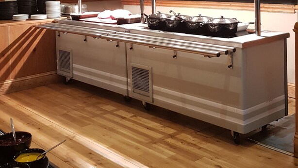 Disposição de buffet com uma placa que diz 'GREAT YORKSHIRE CARVERY' e uma lousa com o mesmo nome.