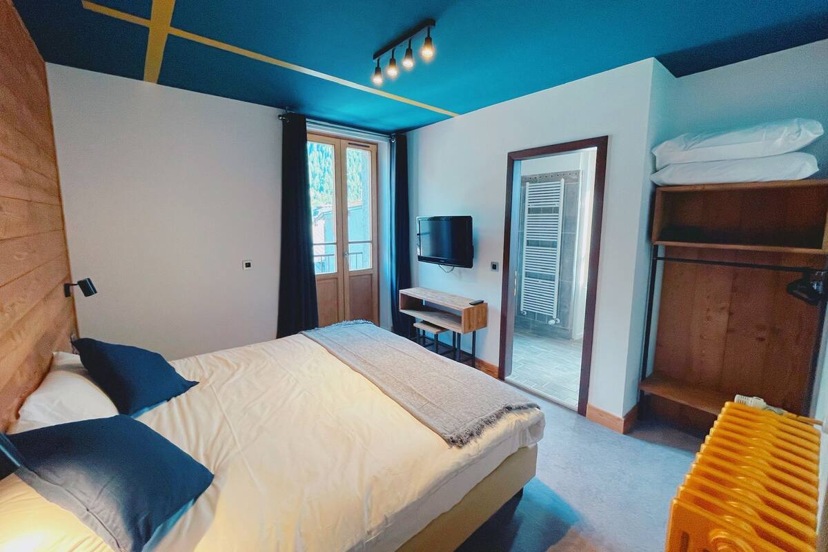 Quarto com cama, televisão, aquecedor e guarda-roupa.