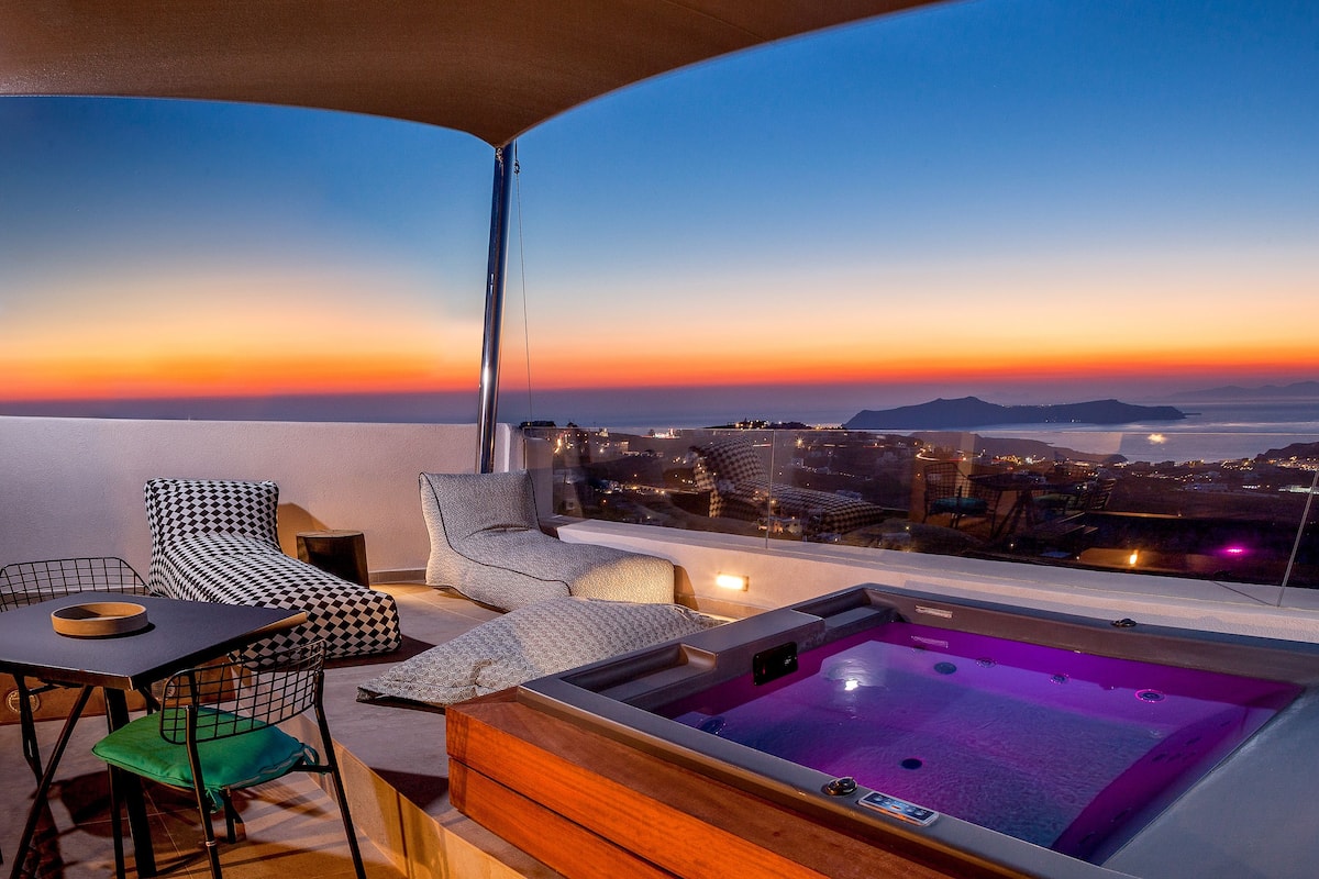 Terraço no terraço com vista para a cidade ao pôr do sol, uma banheira de hidromassagem e assentos modernos.