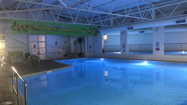 Piscina interna com uma placa que diz "Welcome to Ileraco Holiday Park".