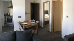 Um espaço compacto com cozinha compacta, área de refeições e quarto.