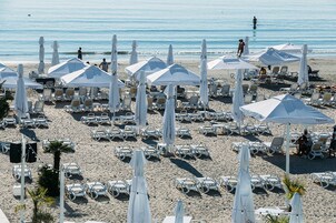 Perto da praia, praia de areia branca, espreguiçadeiras 