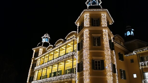 Um edifício com vários andares, janelas amplas e uma varanda.