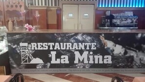 Um balcão de restaurante com uma placa que diz "RESTAURANTE La Mina".