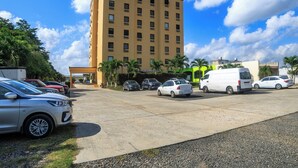A parking lot with multiple cars and a building in the background.