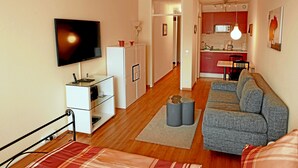 Um apartamento moderno com sala de estar, espaço para refeições e cozinha.