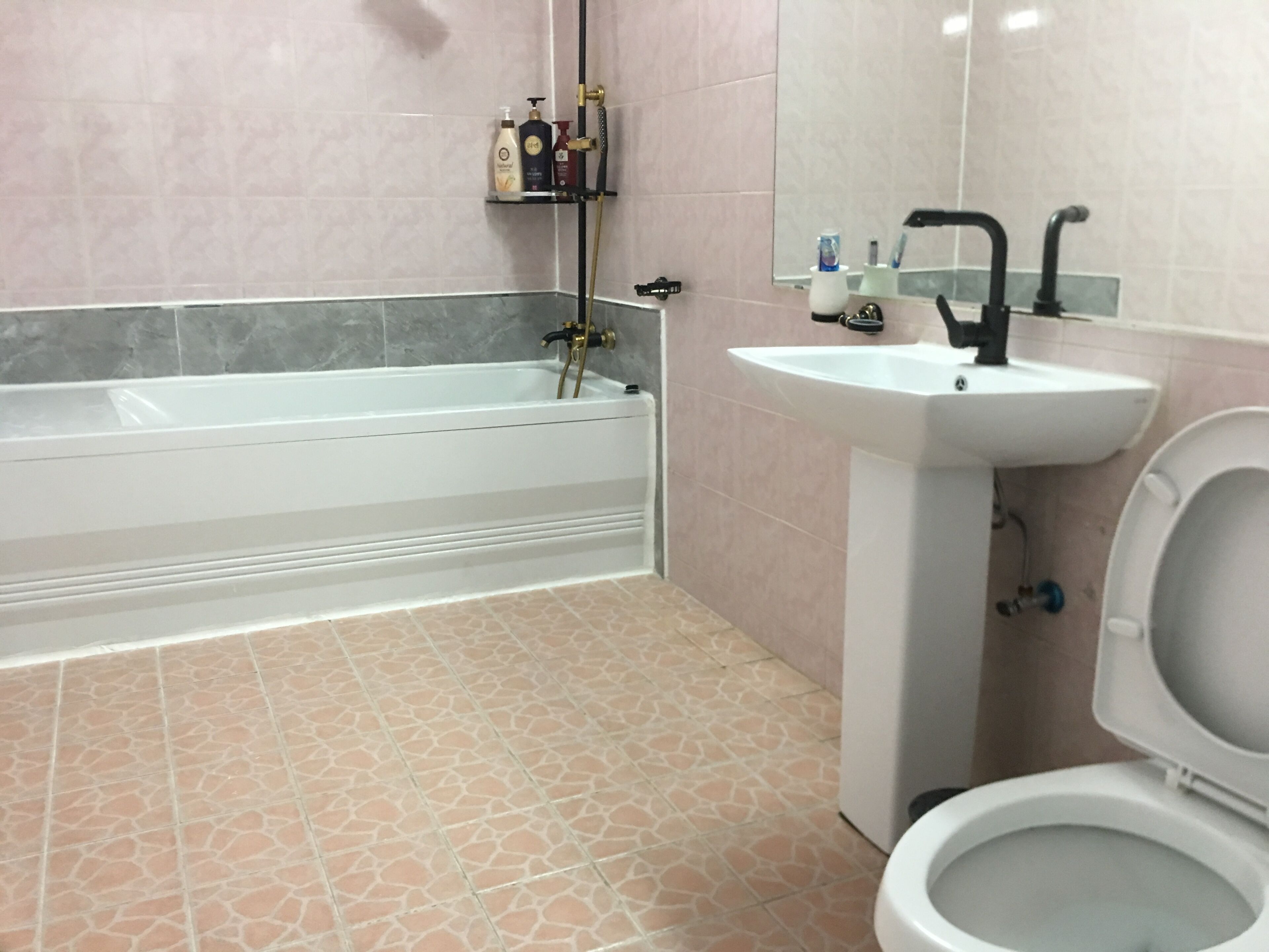 Uma casa de banho com banheira, lavatório e sanita.