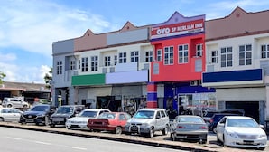 Um hotel com vários andares e fachada marcante em vermelho e branco.