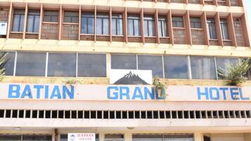 Um edifício de vários andares com a placa 'BATIAN GRAND HOTEL' na fachada.