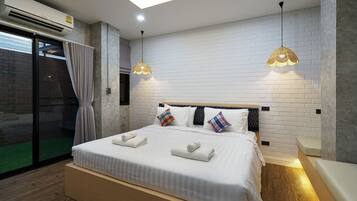 Quarto moderno com uma cama grande, duas mesas de cabeceira, uma luminária no teto e uma porta de vidro deslizante à esquerda.