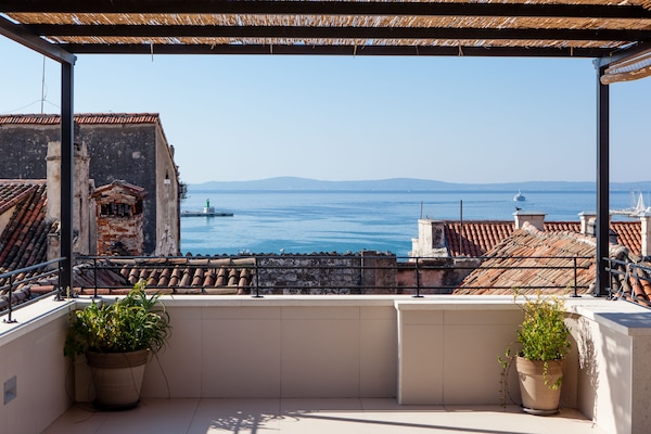 Perto da praia, autocarro para a praia, toldos de praia (sobretaxa)