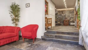 Escadaria que leva a um quarto com um armário branco e uma cadeira de madeira.