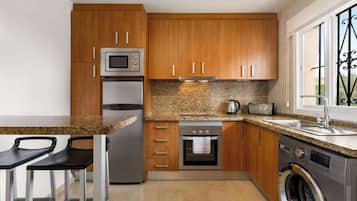 Apartamento superior, 2 quartos, vista para o mar | Cozinha privada | Geladeira, fogão, cooktop, torradeira