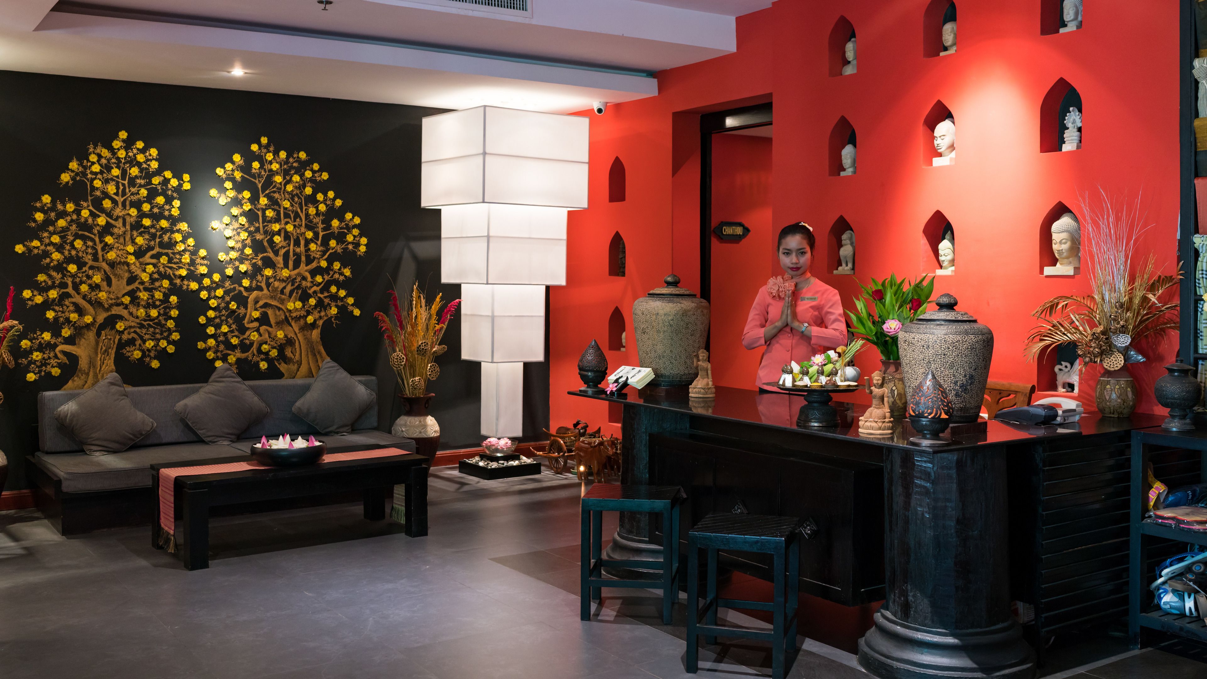 Sala de estar moderna com sofá, mesa de centro e objetos decorativos.