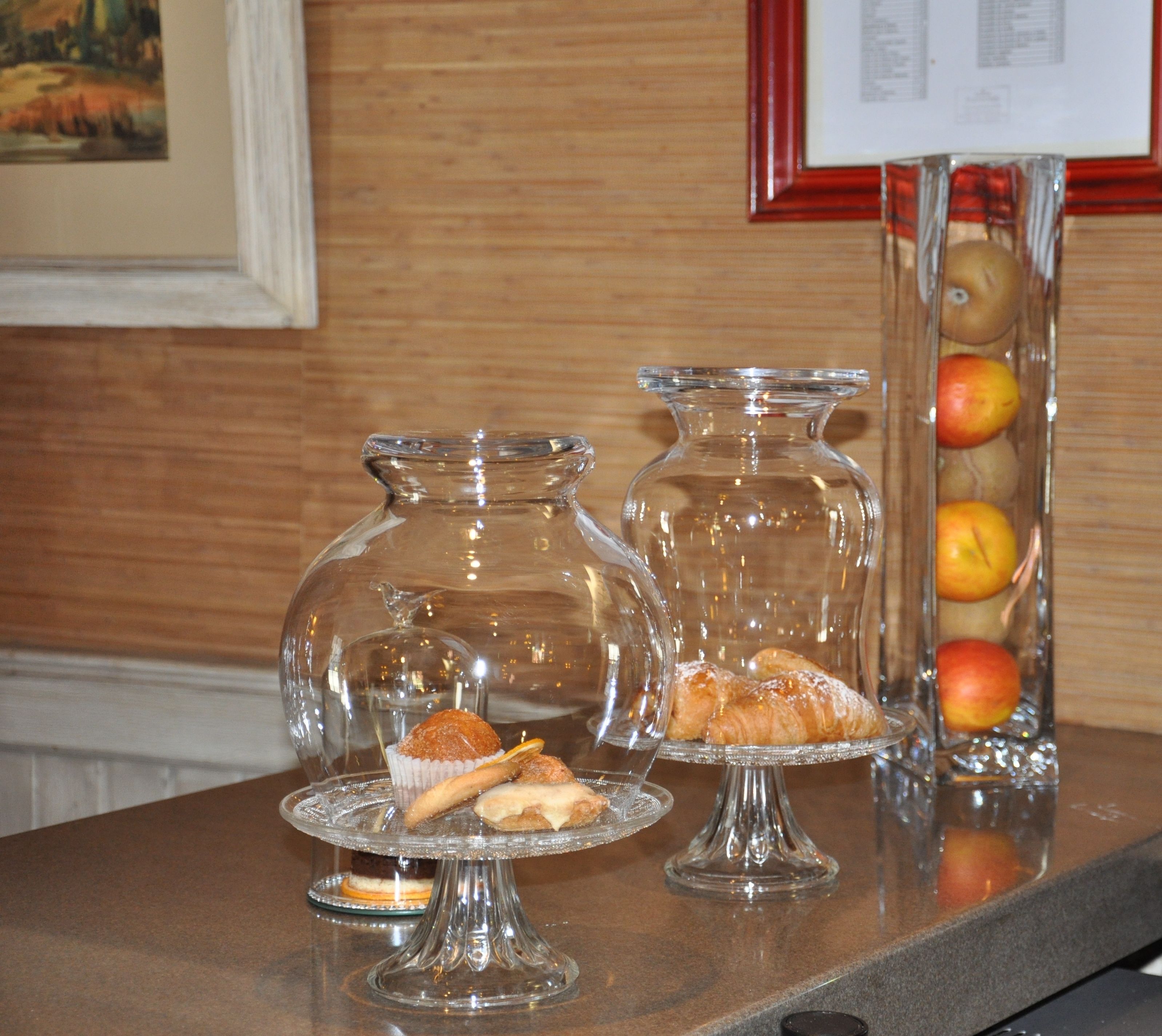 Uma vitrine de vidro com doces e uma composição de frutas.