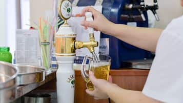 Alguém servindo cerveja de uma torneira em um copo.