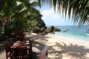 Na praia, praia de areia branca, espreguiçadeiras, toalhas de praia 