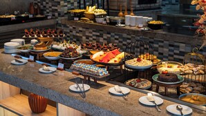 Buffet com diversos alimentos e um balcão de recepção.