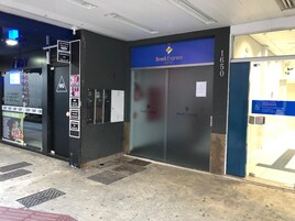 Entrada de um hotel com uma placa azul que diz 'Brasil Express Hotel' e o número '1650'.
