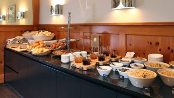 Buffet com diversos alimentos e uma estação de café.