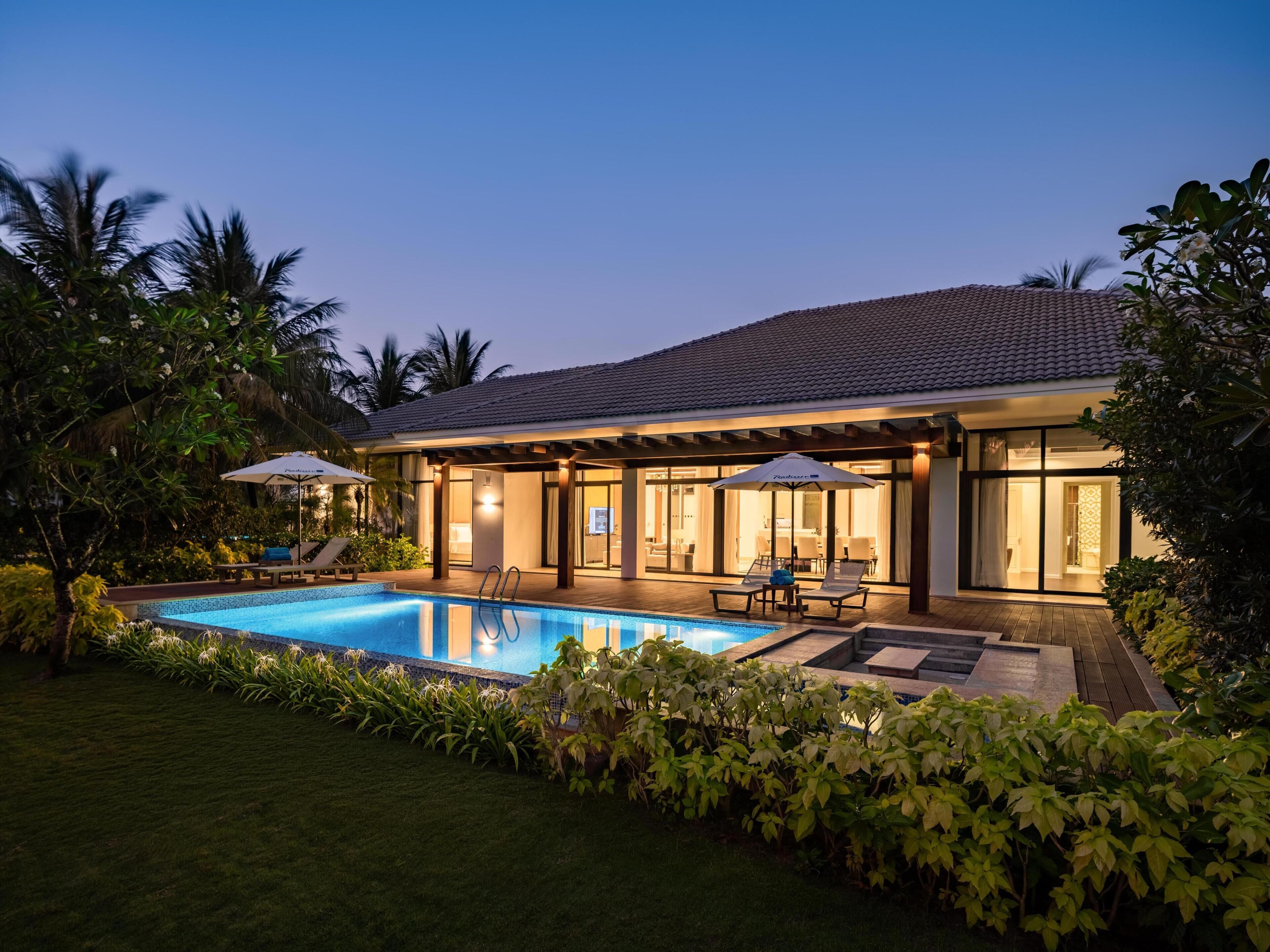 Uma casa moderna com piscina, área de estar ao ar livre e varanda coberta.