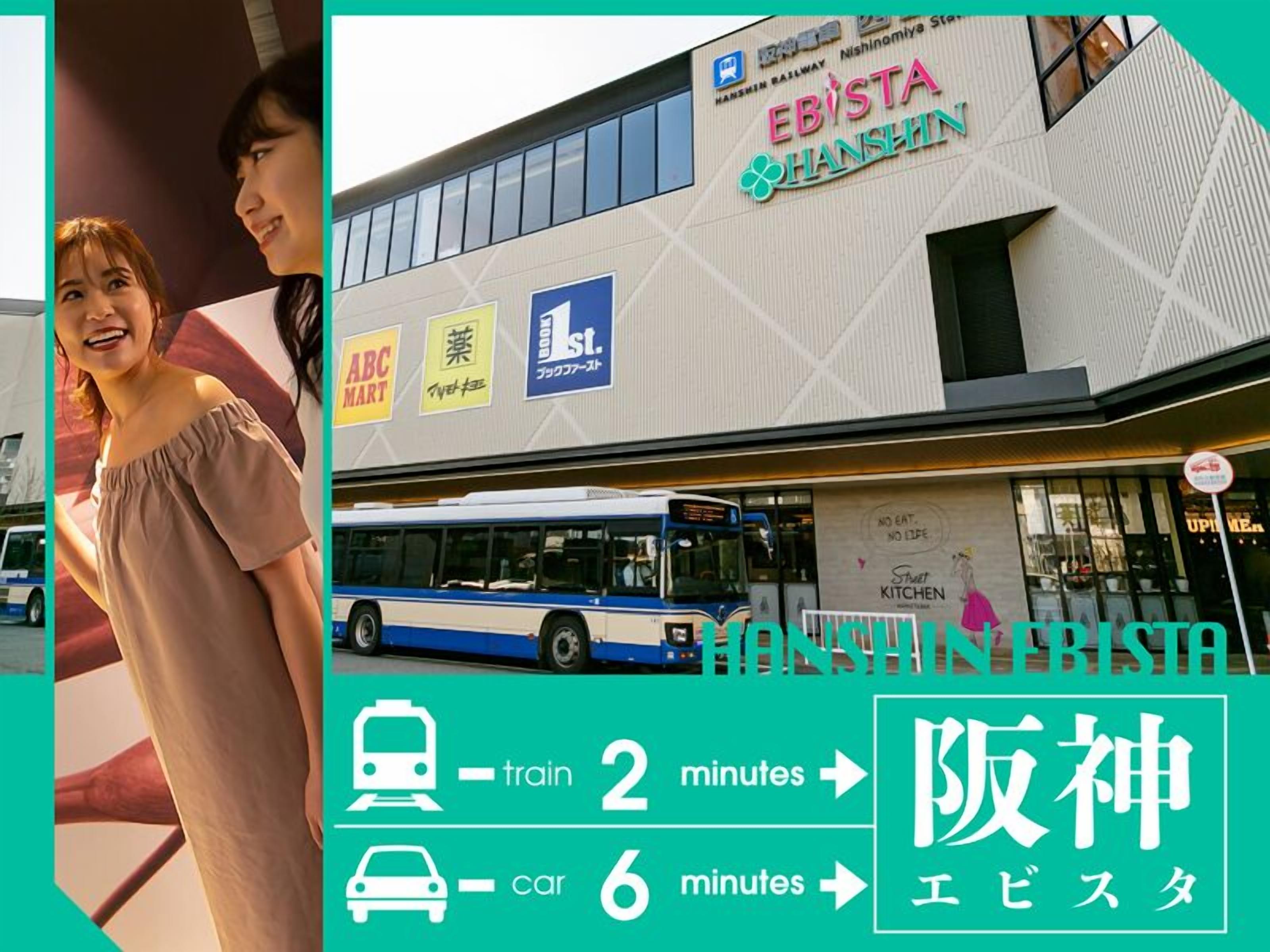 Um edifício com uma placa indicando Ebista Hanshin e um ponto de ônibus.