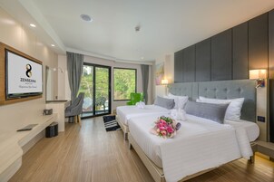 Quarto de hotel moderno com uma cama grande, uma mesa de trabalho e vista para o exterior.
