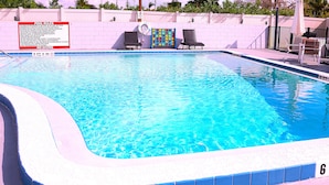 Piscina com aviso detalhando regras, incluindo proibição de mergulho e profundidade de 2 metros.