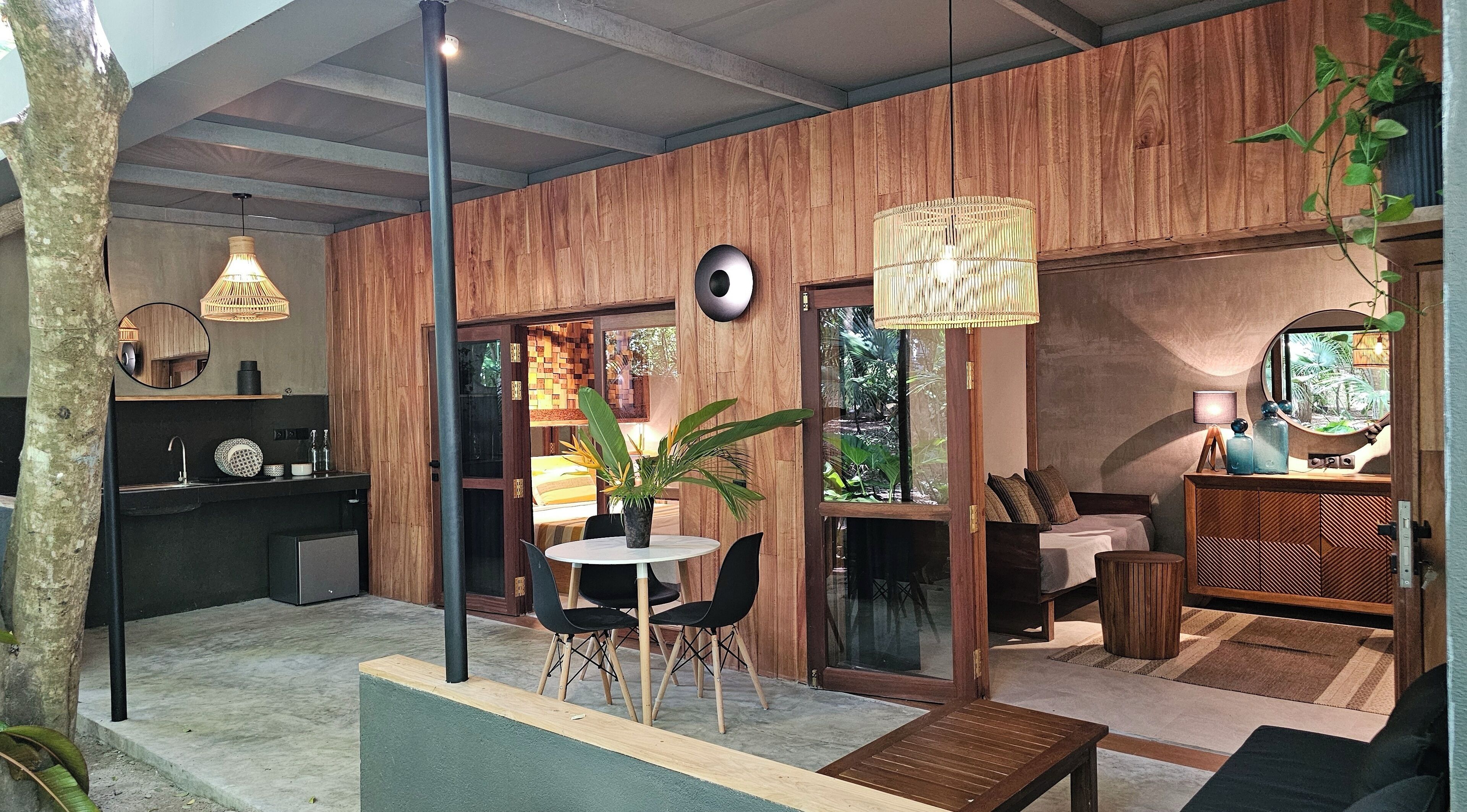 Um interior moderno com cozinha, área de jantar e espaço para sentar.