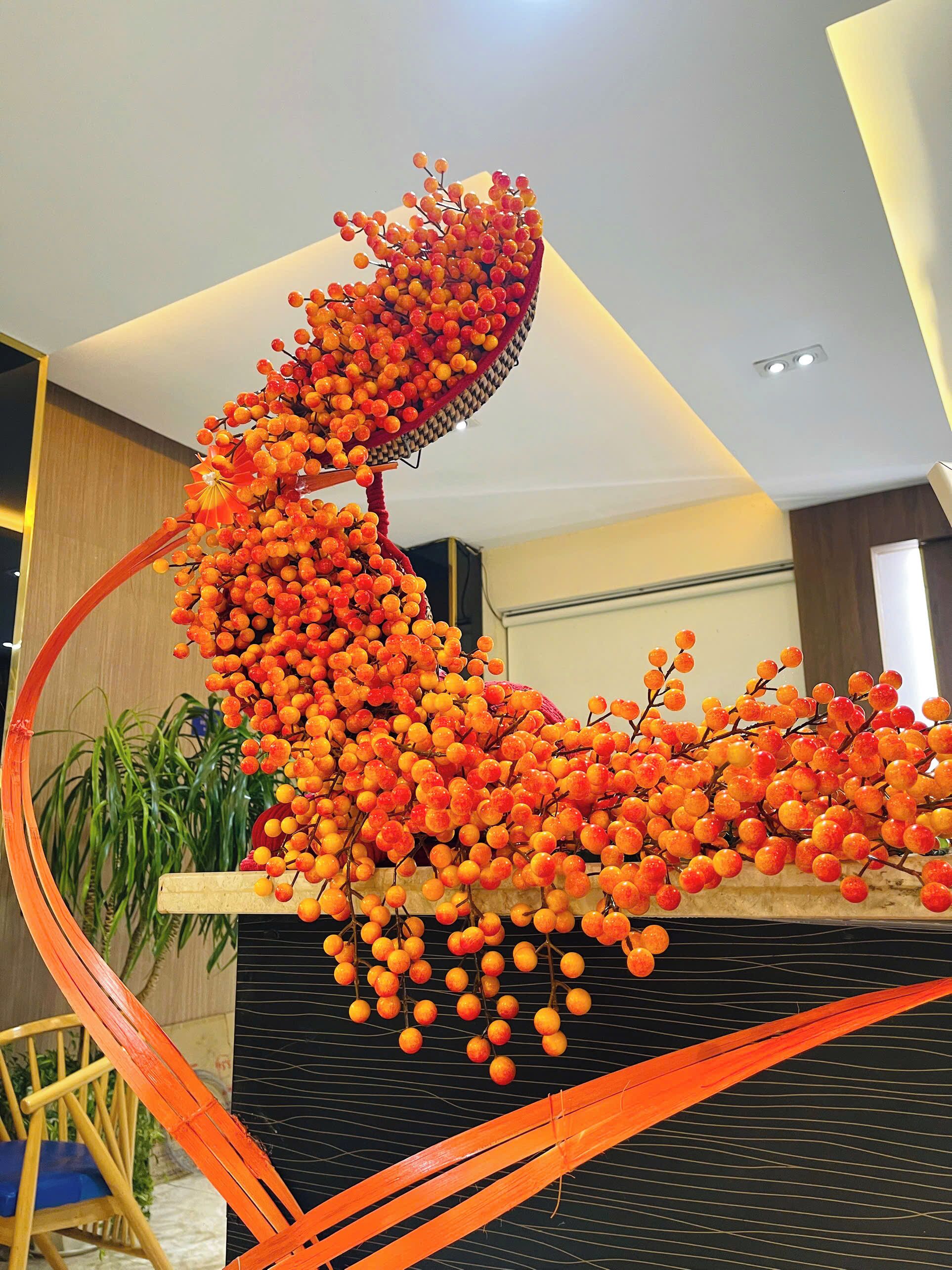 Decoração moderna com uma instalação artística única, destacando esferas em tons de laranja e amarelo.