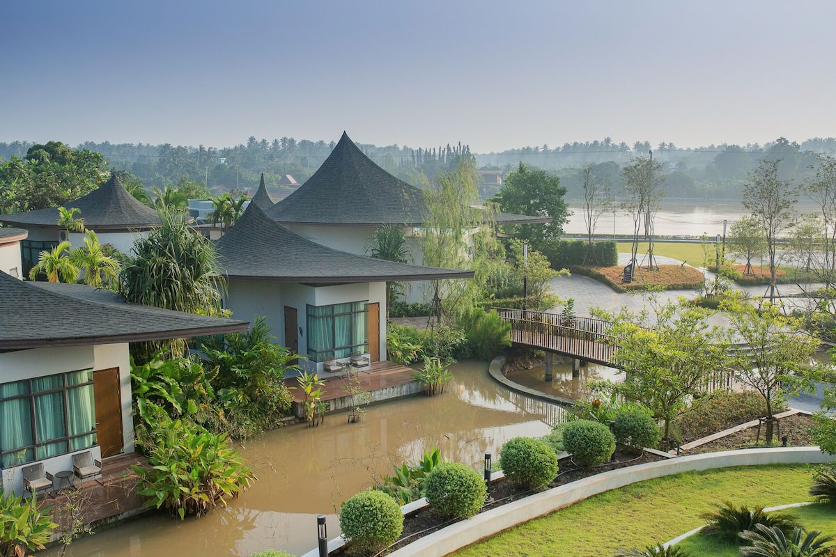 Área residencial com casas, lago e uma ponte.