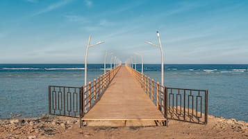 Uma praia privada, espreguiçadeiras, guarda-sóis de praia