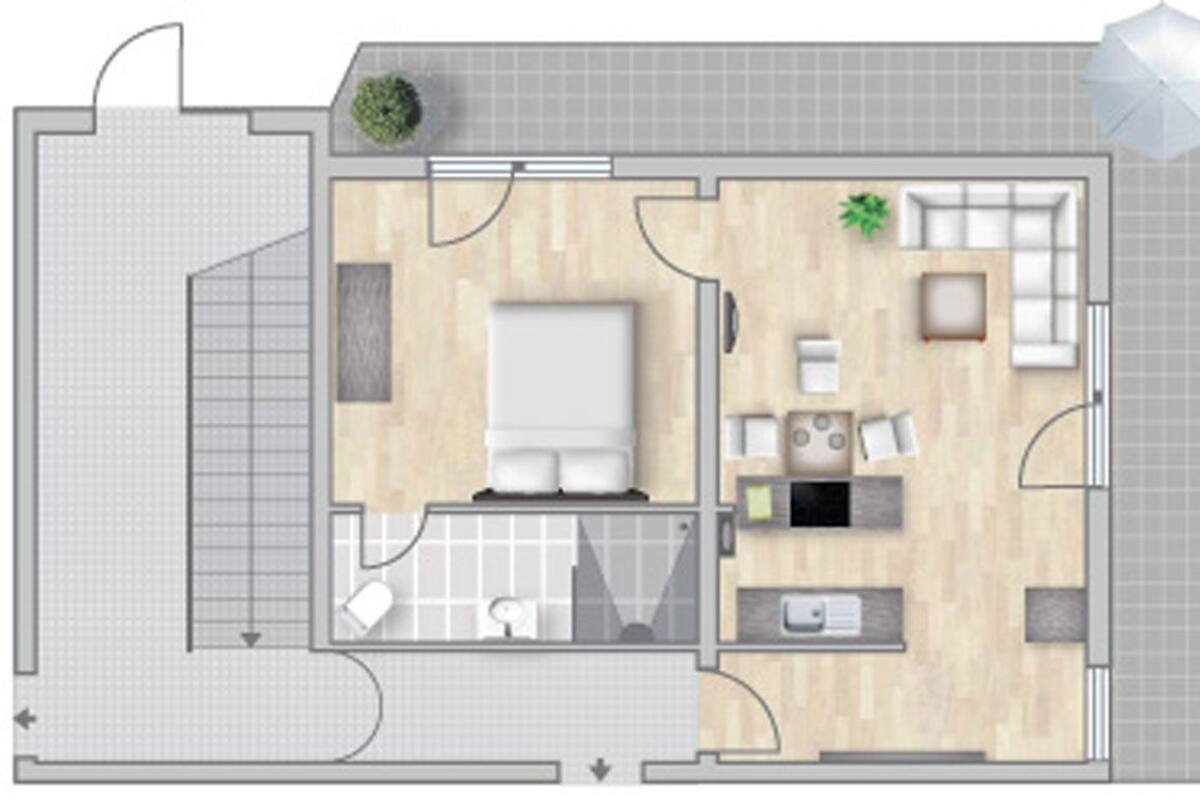 Disposição de quarto de hotel com cama, área de estar, cozinha compacta e banheiro pequeno.