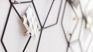 Design geométrico na parede com moldura metálica.