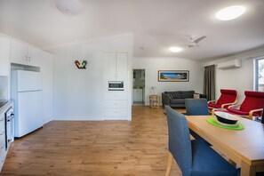 Apartamento Deluxe, 1 cama queen-size | Sala de estar | TV de ecrã plano 