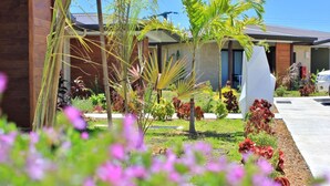 Um edifício moderno com um jardim bem cuidado, repleto de plantas e flores.