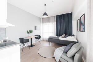 Um apartamento moderno, bem iluminado, com cozinha, sala de jantar e um espaço de estar aconchegante.