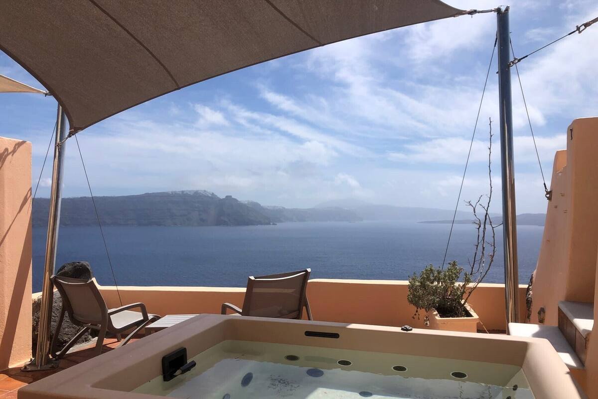 Uma banheira de hidromassagem com vista para o mar e falésias.