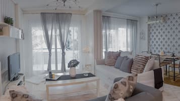 Apartamento superluxo, 3 quartos | Área de estar | TV de tela plana, console de videogame