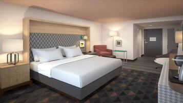 Quarto de hotel com cama, mesa de cabeceira, luminária, cadeira, escrivaninha e carpete.