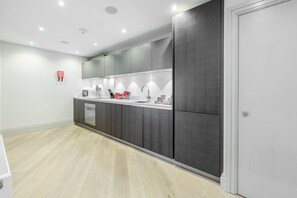 Um frigorífico, um micro-ondas, um forno, uma placa de cozinha