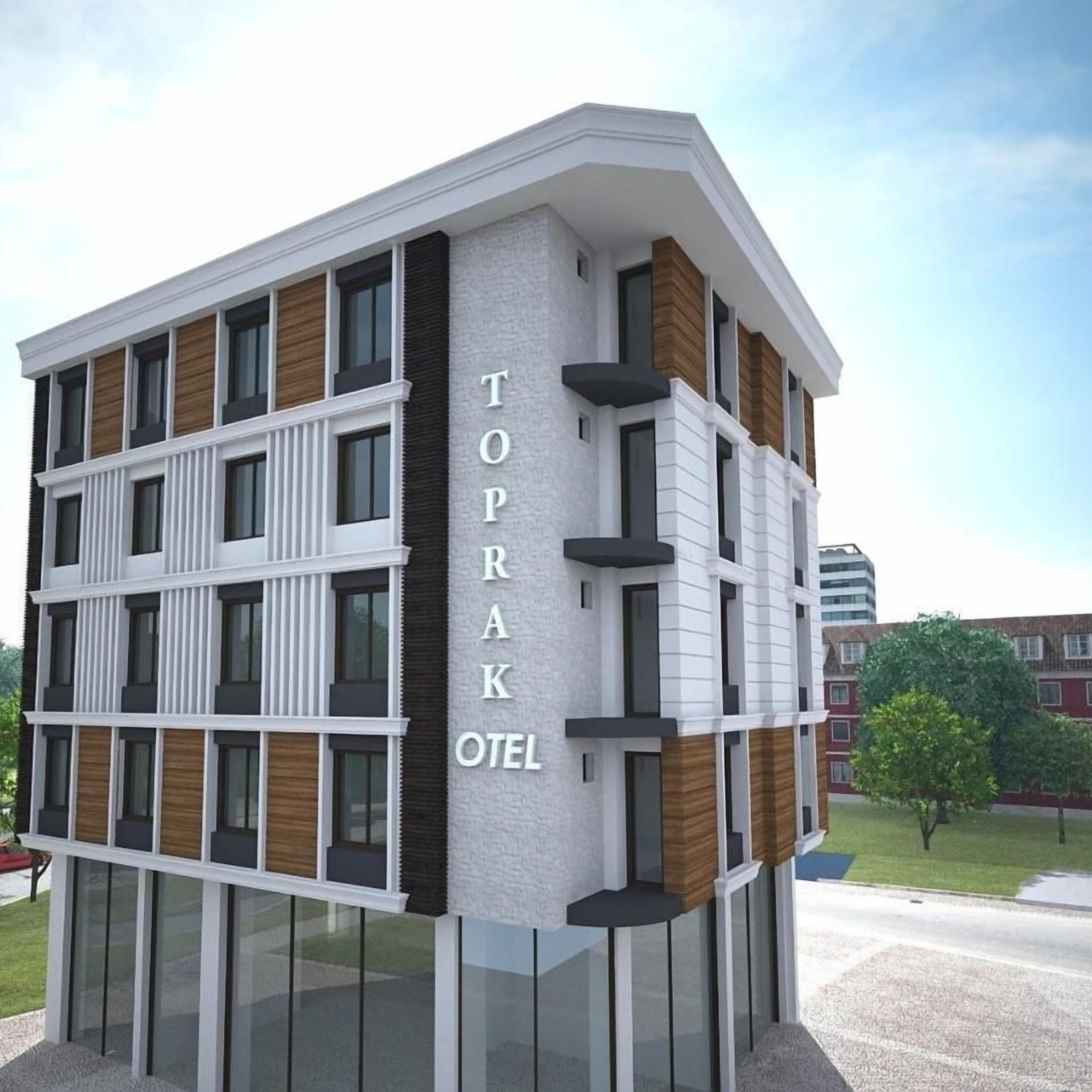 Um edifício moderno de hotel com fachada branca, várias janelas e uma placa com a inscrição 'TOPRAK HOTEL'.