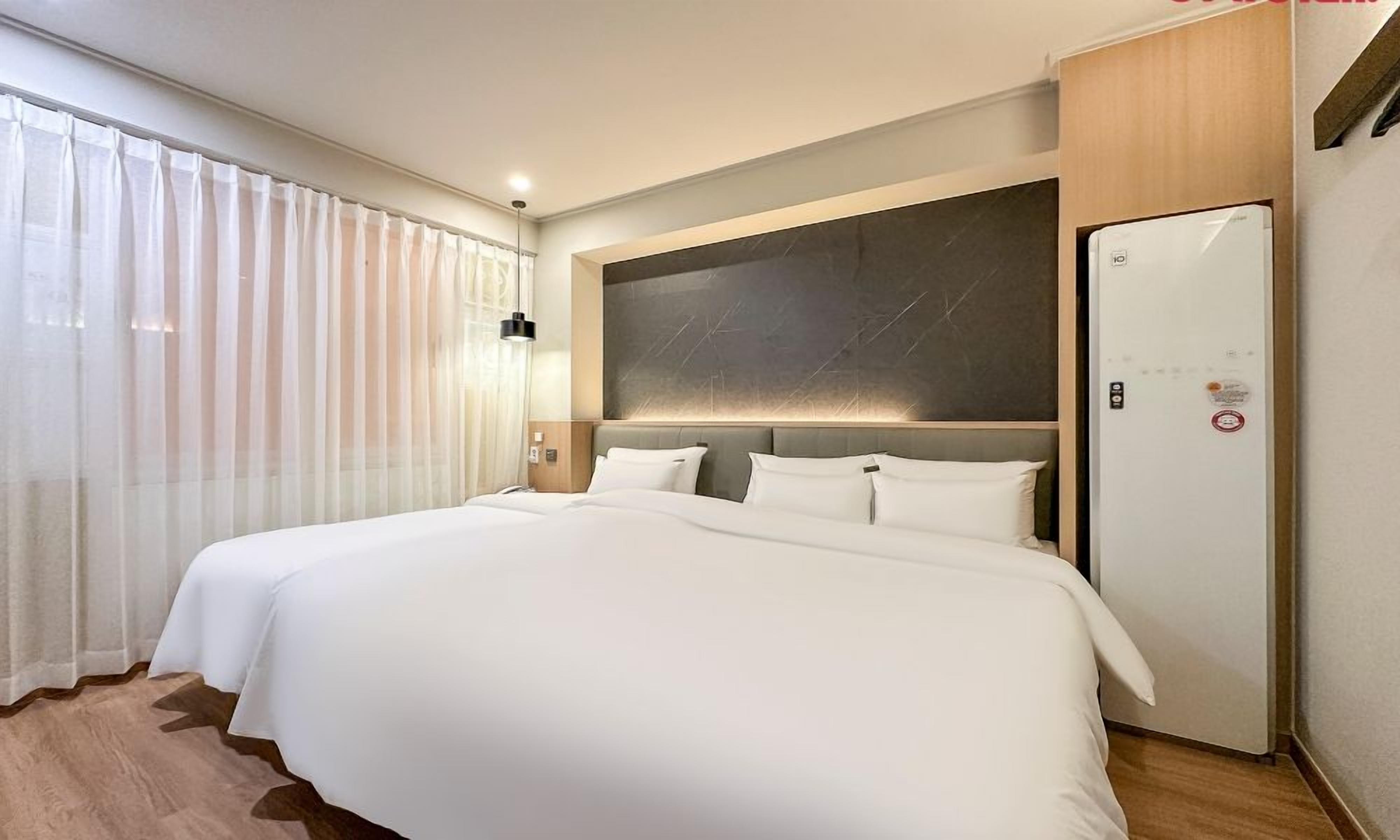 Quarto de hotel com uma cama grande, um guarda-roupa e design moderno.