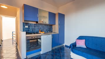 Apartamento, 2 quartos | Cozinha americana privada | Geladeira, fogão, cooktop, lava-louças
