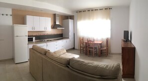 Um frigorífico/congelador grande, um micro-ondas, utensílios de cozinha