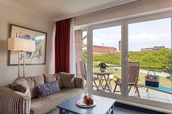 Quarto casal superior | Área de estar | TV de tela plana