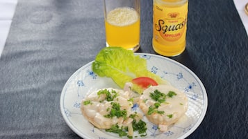 Um prato com comida e uma bebida sobre a mesa.