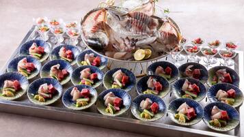 Uma seleção de frutos do mar com vários peixes e mariscos dispostos numa bandeja.