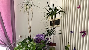 Um armário de madeira com diversos vasos de plantas e flores.