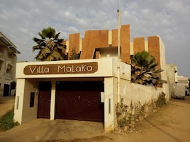 Villa Malaka, um edifício com entrada destacada e uma placa sobre as portas.